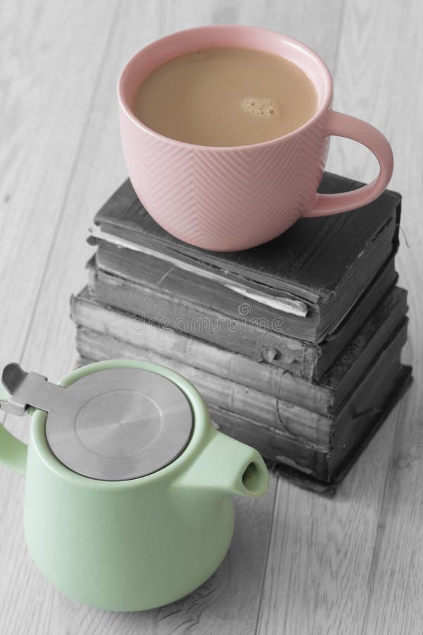 Cup of Tea in a Pink Cup with Pastel Green Teapot and a Stack of Old ...