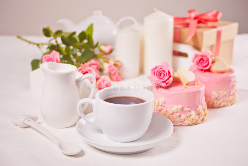 A Cup of Tea, Pink Roses and Small Cakes on the White Table Stock Image ...