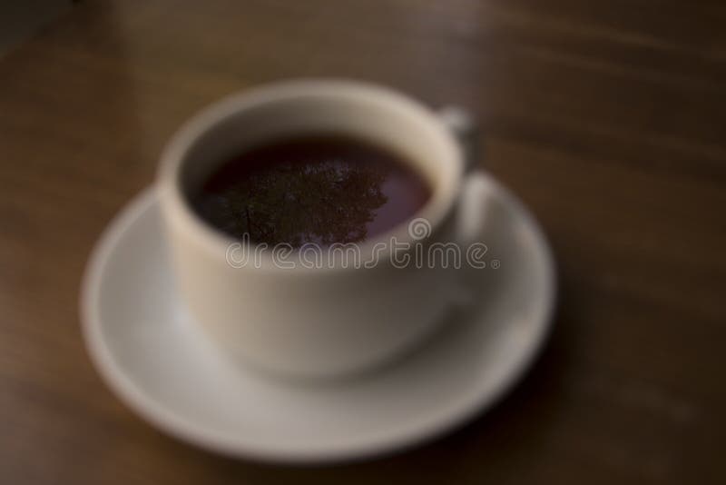 A Cup of Tea with the Reflection of the Tree. Stock Image - Image of ...