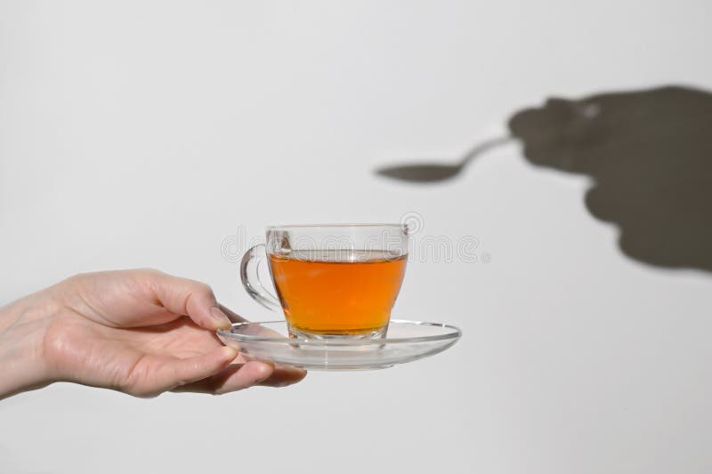 Cup of Tea and Shadow of Spoon and Hand Stock Image - Image of antique ...