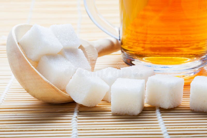 Cup of Tea and Sugar in a Wooden Spoon on the Mat Stock Image - Image ...
