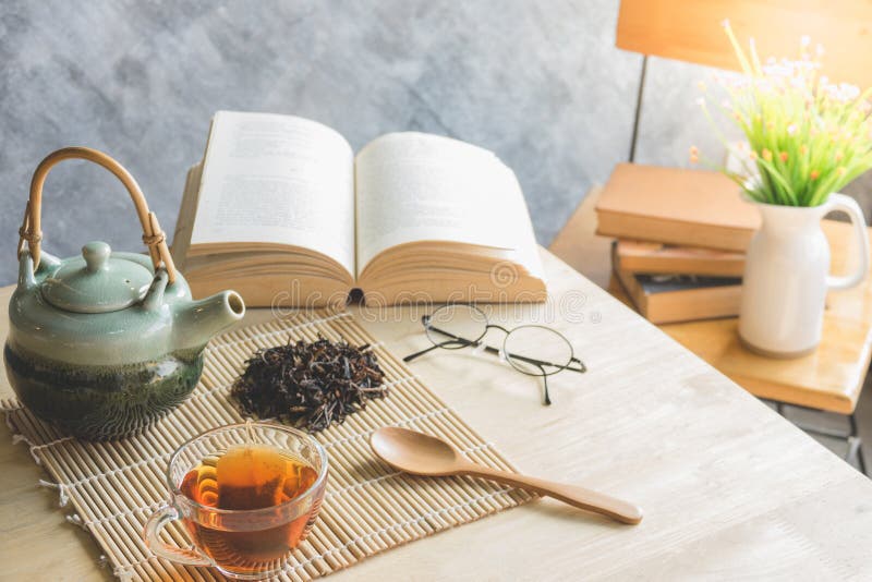 A Cup of Tea with Tea Pot and Dride Tea Leaf with Reading Book Stock ...