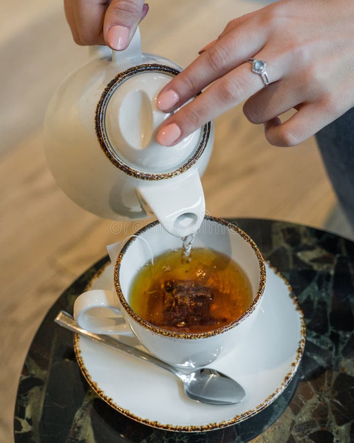 Cup of Tea with Teabag, Female Hands Holding a Teapot Stock Image ...
