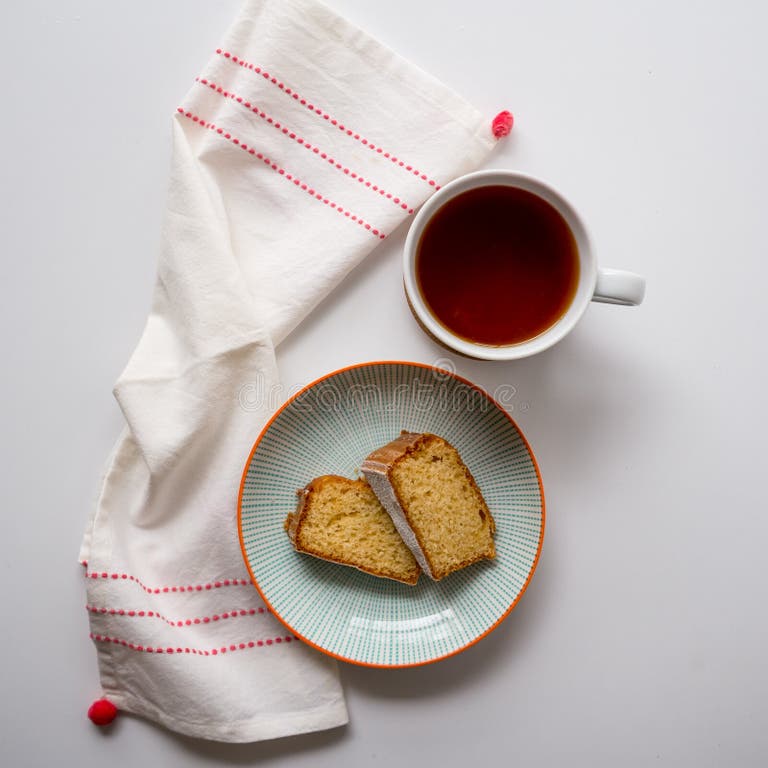 Cup of Tea and Two Slices of Sponge Cake in a Plate on a White Table ...