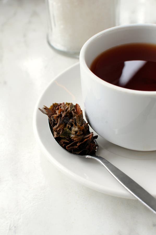 A Cup of Tea Wit a Spoon Full of Tea Leaves. Stock Image - Image of ...