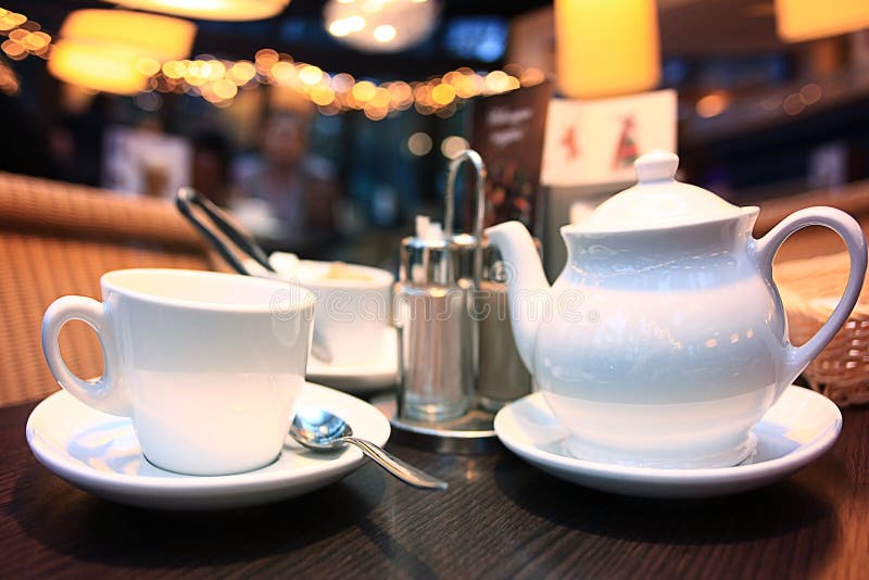 Cup and teapot in cafe stock photo. Image of comfort - 58553286