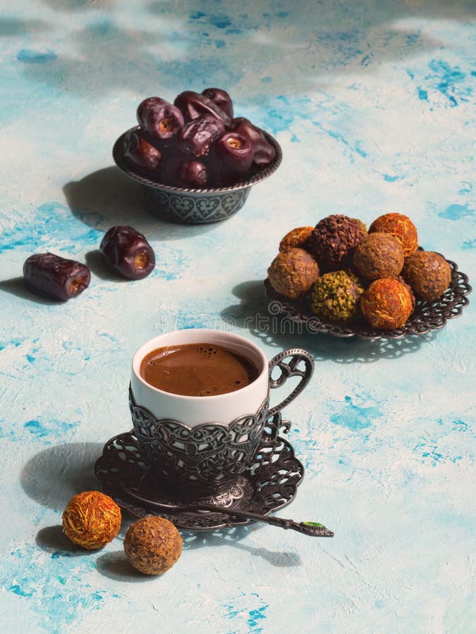 A Cup of Turkish Coffee with Arabic Sweets with Dates on a Blue Table ...