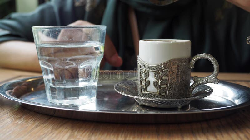A Cup of Turkish Coffee Served with Glass of Water on Table Stock Video ...