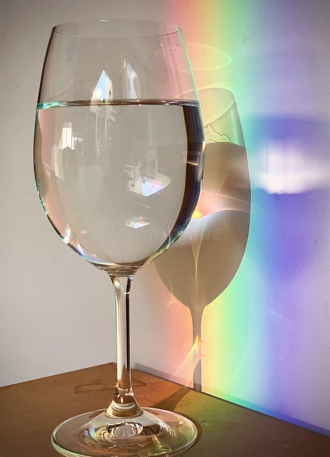 Cup with Water Reflecting the Rainbow on the Wall. Stock Photo - Image ...