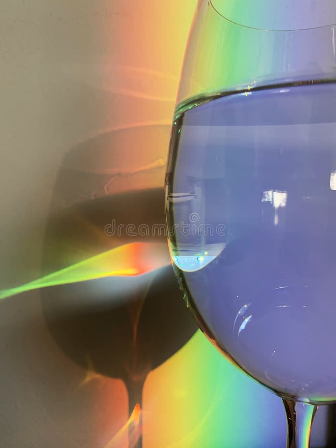Cup with Water Reflecting the Rainbow on the Wall. Stock Photo - Image ...