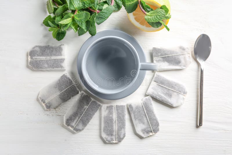Cup with Water and Tea Bags on Wooden Table Stock Photo - Image of flat ...