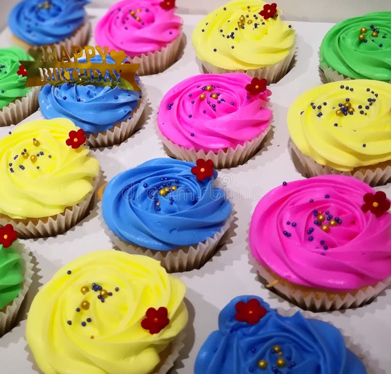 Cupcakes with Colourful Creamy Icing Toppling Stock Image - Image of ...