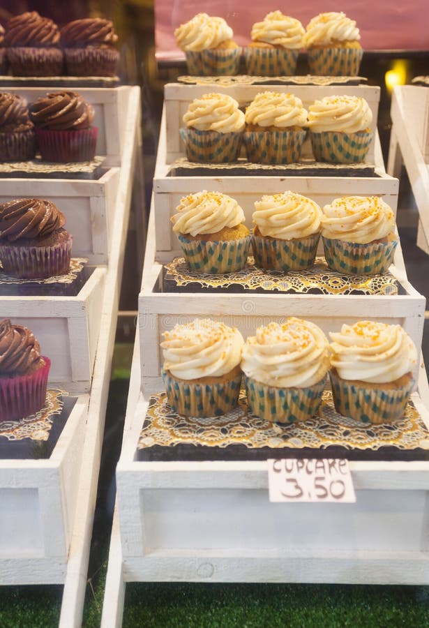 Cupcakes on Display in Shop Window Stock Photo - Image of display ...