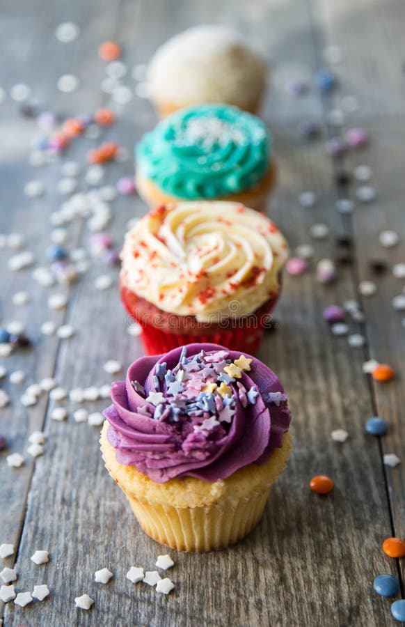 Cupcakes in a Row on Wooden Table Stock Photo - Image of sweet, blurred ...