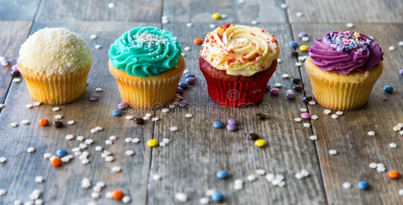 Cupcakes in a Row on Wooden Table Stock Image - Image of cupcake ...