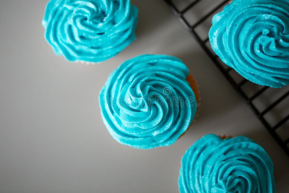 Cupcakes with Blue Icing on a Neutral Grey Worktop with Wire Rack Stock ...