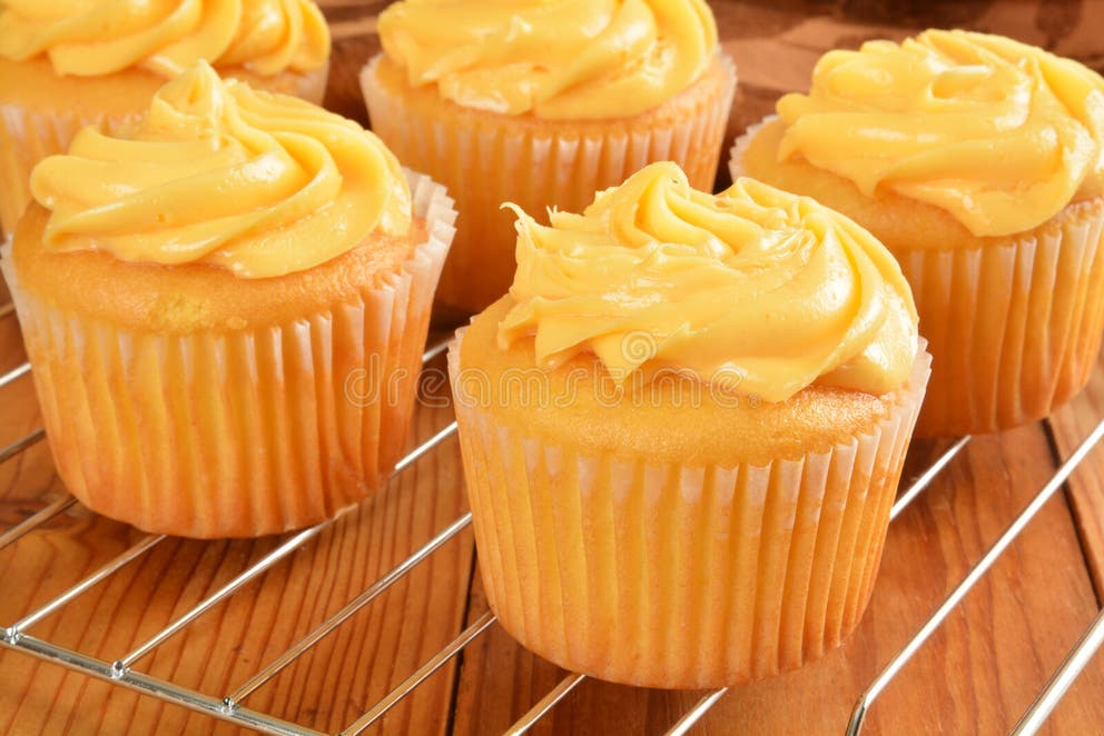 Cupcakes on a Wire Cooling Rack Stock Photo - Image of icing, snack ...