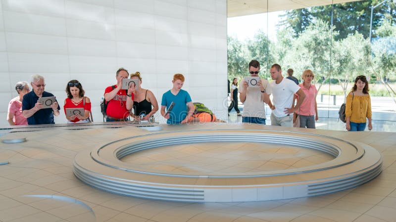 Group of People in Apple Store Looking at Infinite Loop Apple ...
