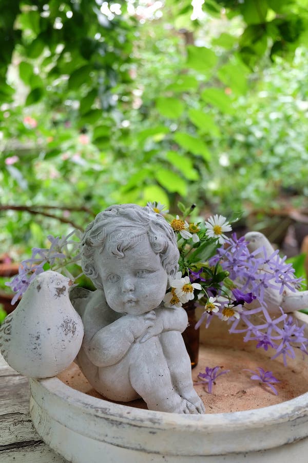 Cupid and flowers stock photo. Image of peaceful, face - 72354546