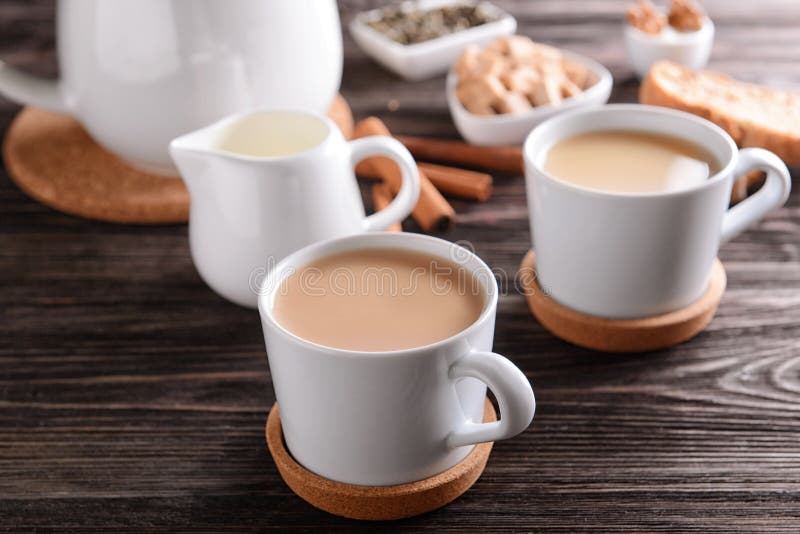 Cups of Aromatic Tea with Milk on Table Stock Photo - Image of flavor ...