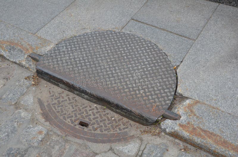 Manhole in the Curb Line between the Grass and Asphalt Stock Photo ...