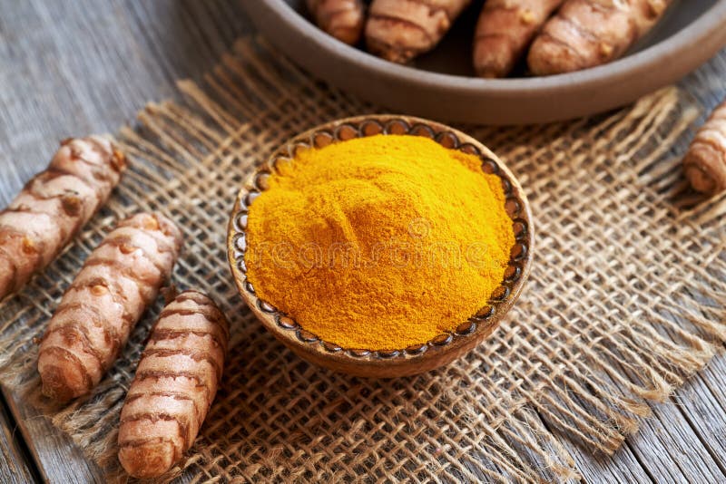 Curcuma Powder and Fresh Turmeric Root on a Table Stock Image - Image ...