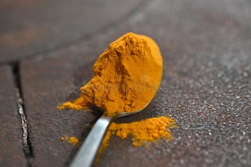 Curcuma or Turmeric Powder on a Tea Spoon on Dark Background Stock ...