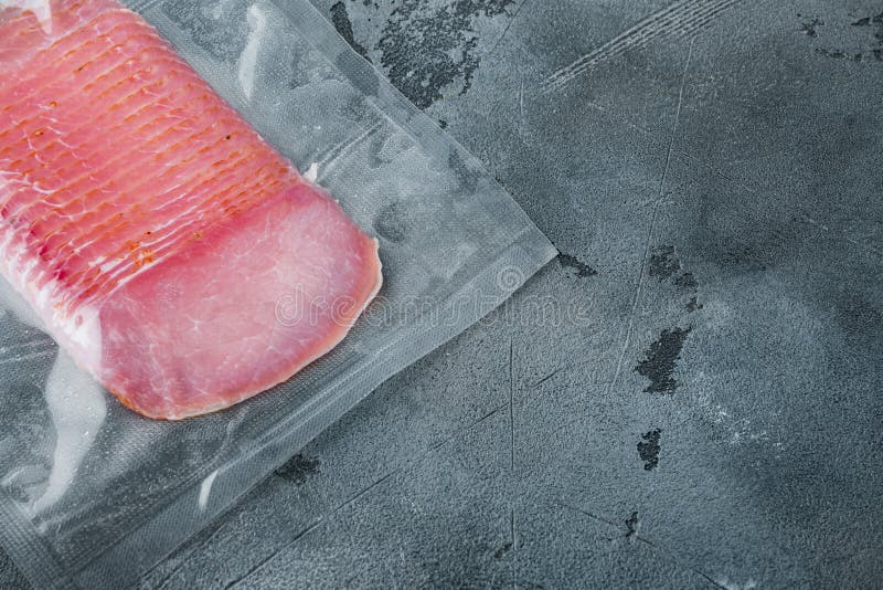 Cured Meat Pork Ham, Vacuum Packed, on Gray Stone Background, with Copy ...
