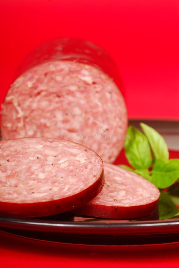 Cured salami with basil stock image. Image of market - 15144241