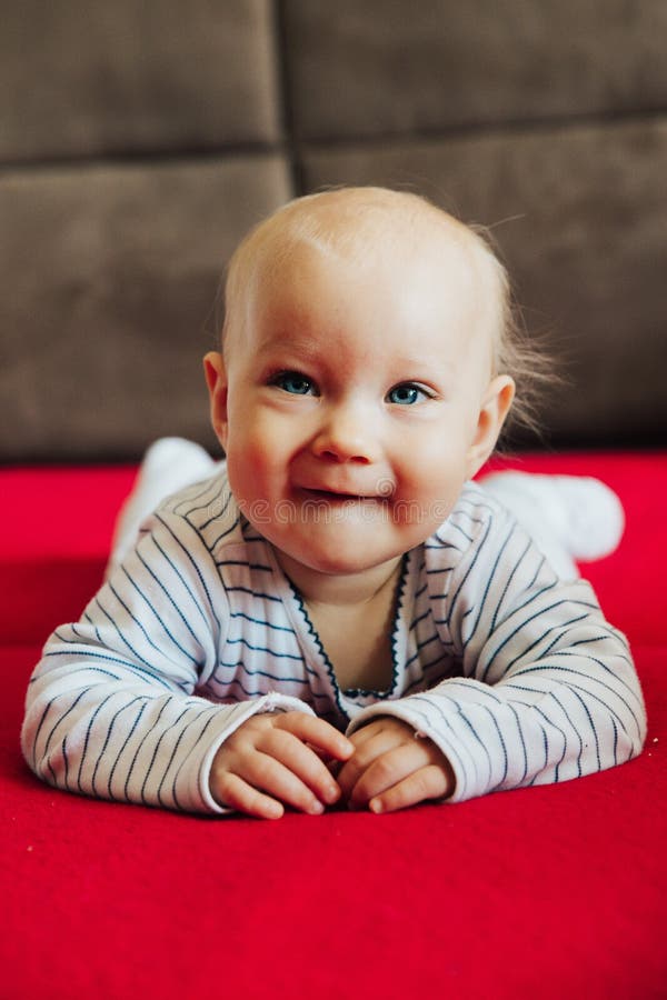 Curious Baby Girl Lying on Bed, Smiling Front View Stock Image - Image ...