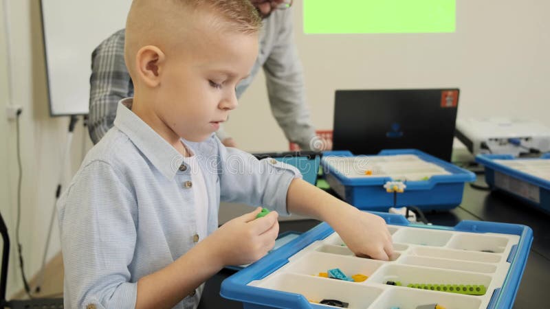Curious Blond Caucasian Kid Experiences How To Construct the Plastic ...