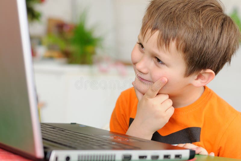 Curious boy with computer stock photo. Image of laptop - 53123220