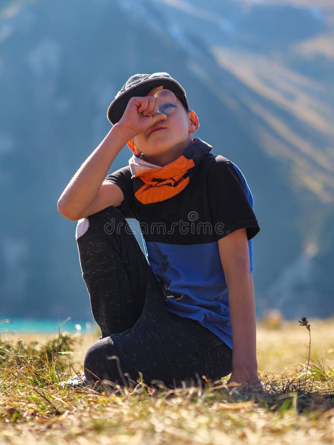 Curious Boy Explores the World. a Boy Plays with a Magnifying Glass ...