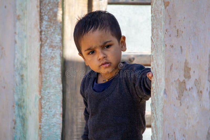 Curious Boy Peeking Behind Wall Stock Image - Image of hide, exploring ...