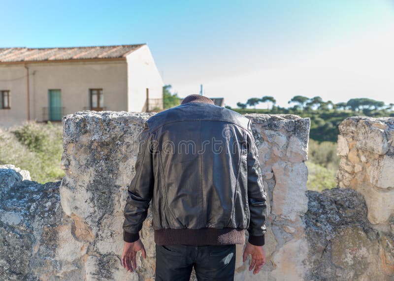 A Curious Image of a Man without a Head Wearing Black Pants and a ...