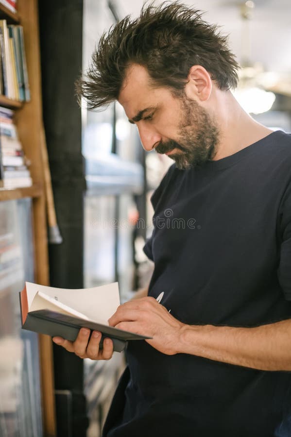 Curious Man Choosing Book in His Library at Home Stock Image - Image of ...