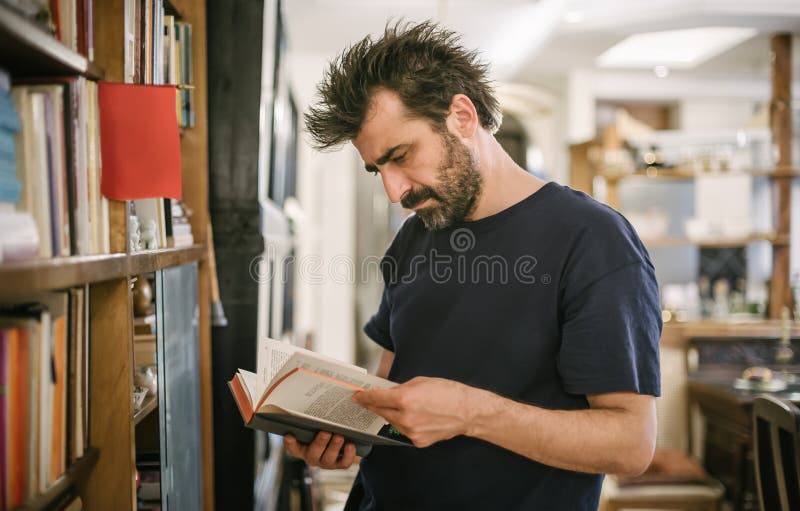 Curious Man Choosing Book in His Library at Home Stock Photo - Image of ...