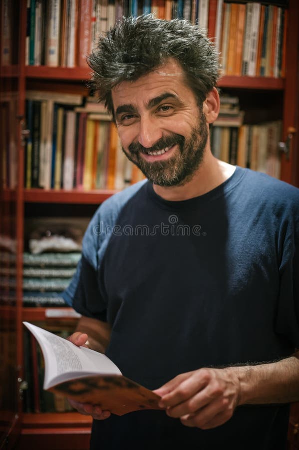 Curious Man Choosing Book in His Library at Home Stock Image - Image of ...