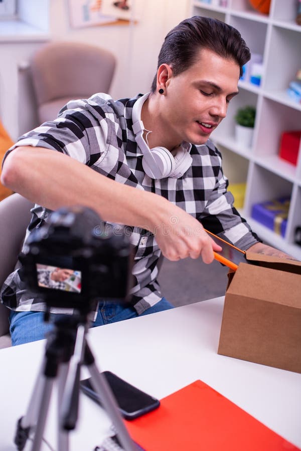 Curious Professional Video Blogger Getting Tablet from Cardboard ...