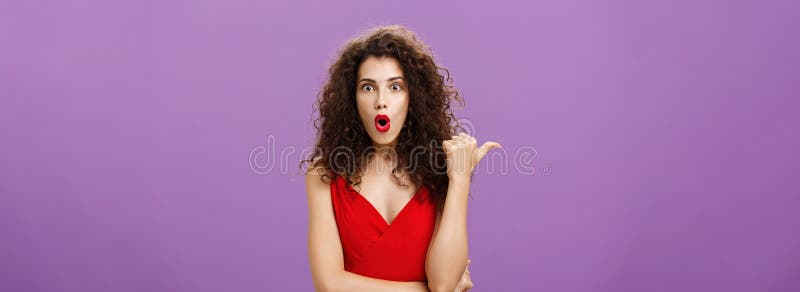 Curious And Questioned Amazed Woman With Curly Hairstyle In Stylish Red