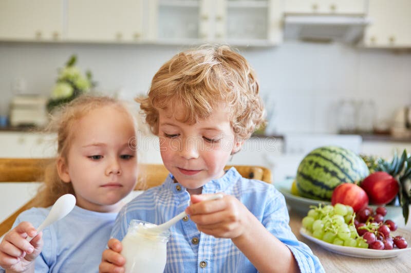 Curious Siblings Eating Parfait at Home Stock Photo - Image of female ...