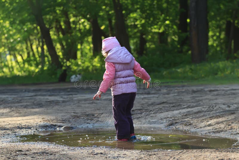 Curious Toddler Girl Walking in Summer Puddle Stock Photo - Image of ...