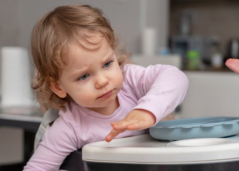 A Curious Toddler Interacting with Objects at the Table in a Cozy Home ...