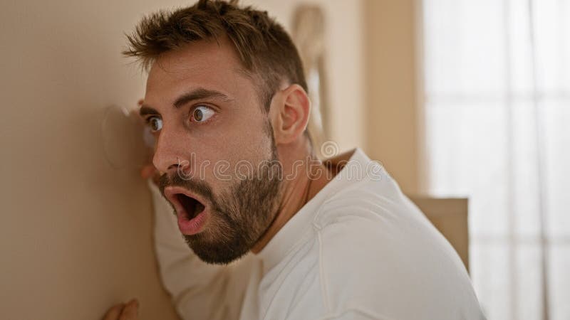 Curious Young Hispanic Man Surprised while Eavesdropping through Wall ...