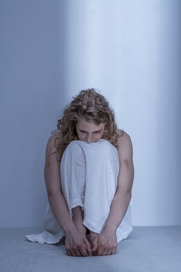 Curled up scared victim stock image. Image of teenager - 57091853