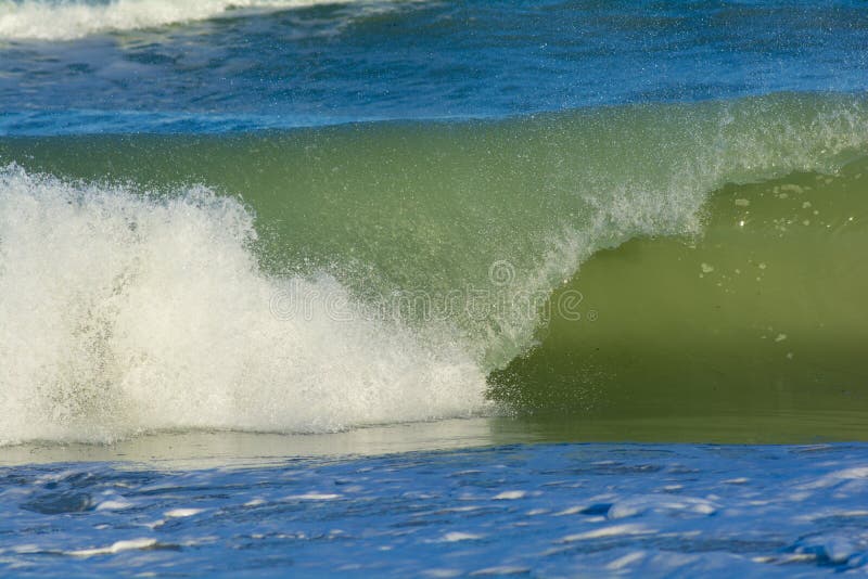 Curling waves at the beach stock image. Image of splashing - 90304819