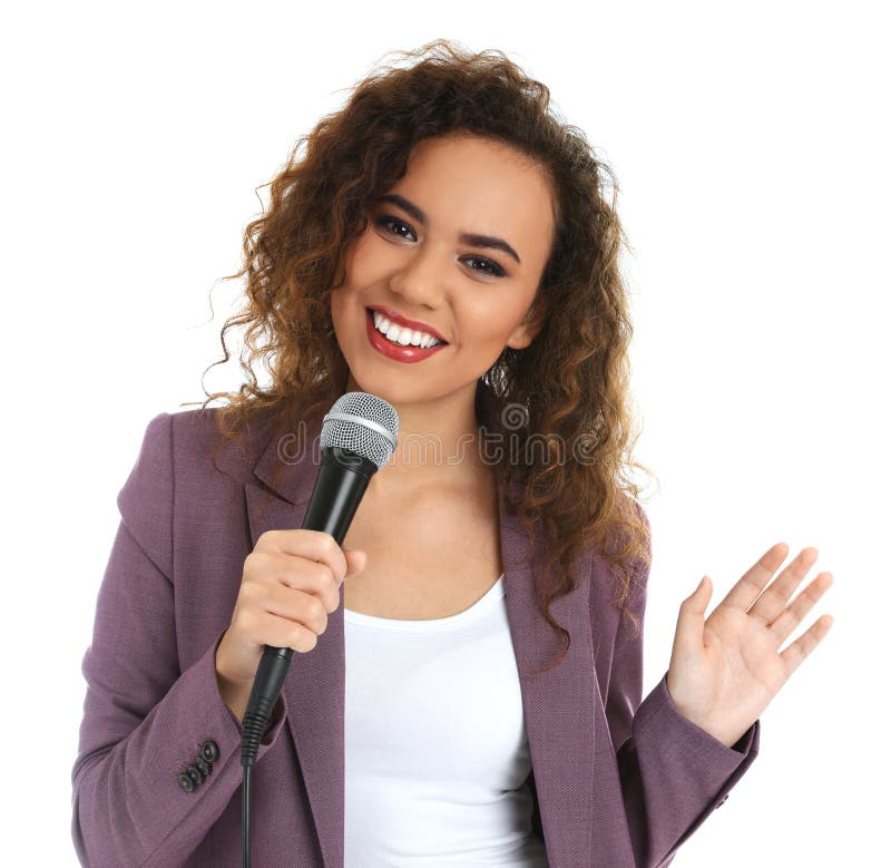 Curly African American Woman In Suit Singing With Microphone On White