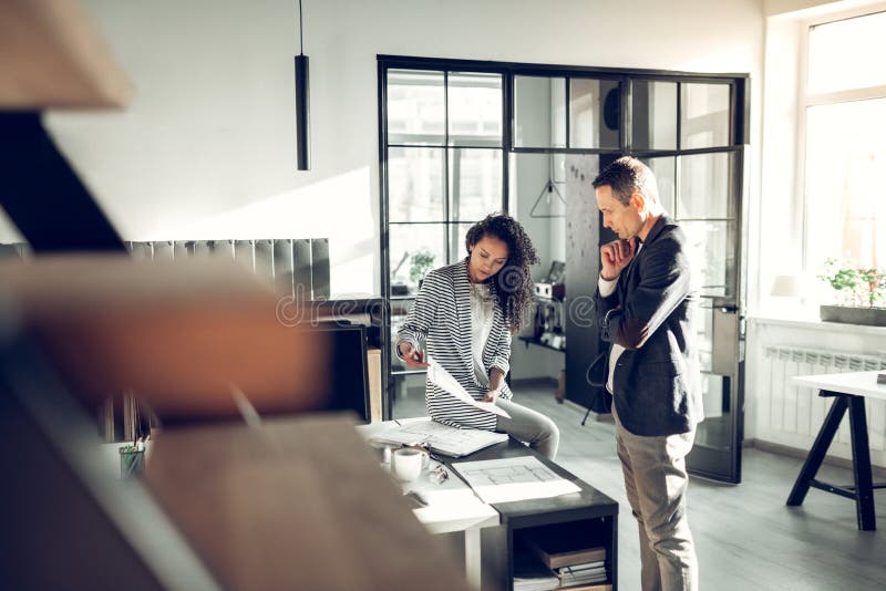 Curly Assistant of Interior Designer Telling Him about the Project ...