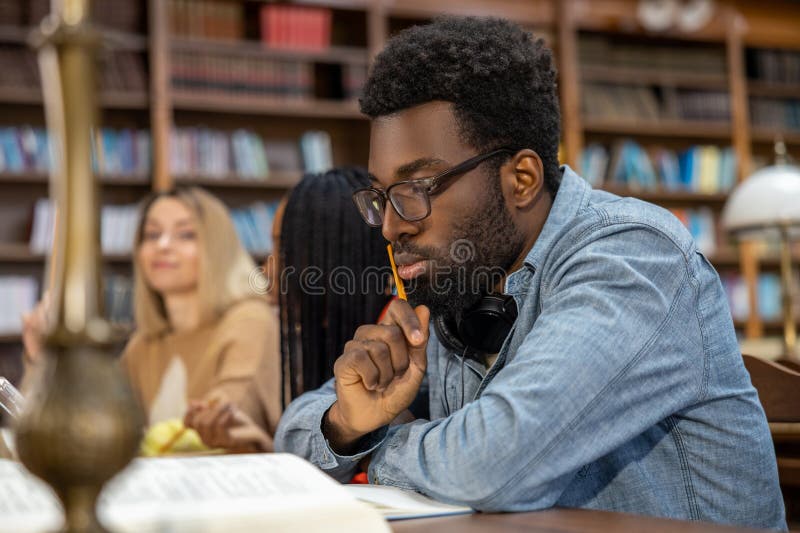 Curly-haired Bearded African American Man in the Library Looking ...