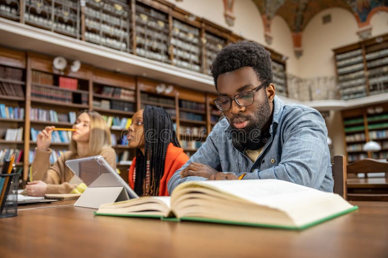 Curly-haired Bearded African American Man in the Library Looking ...
